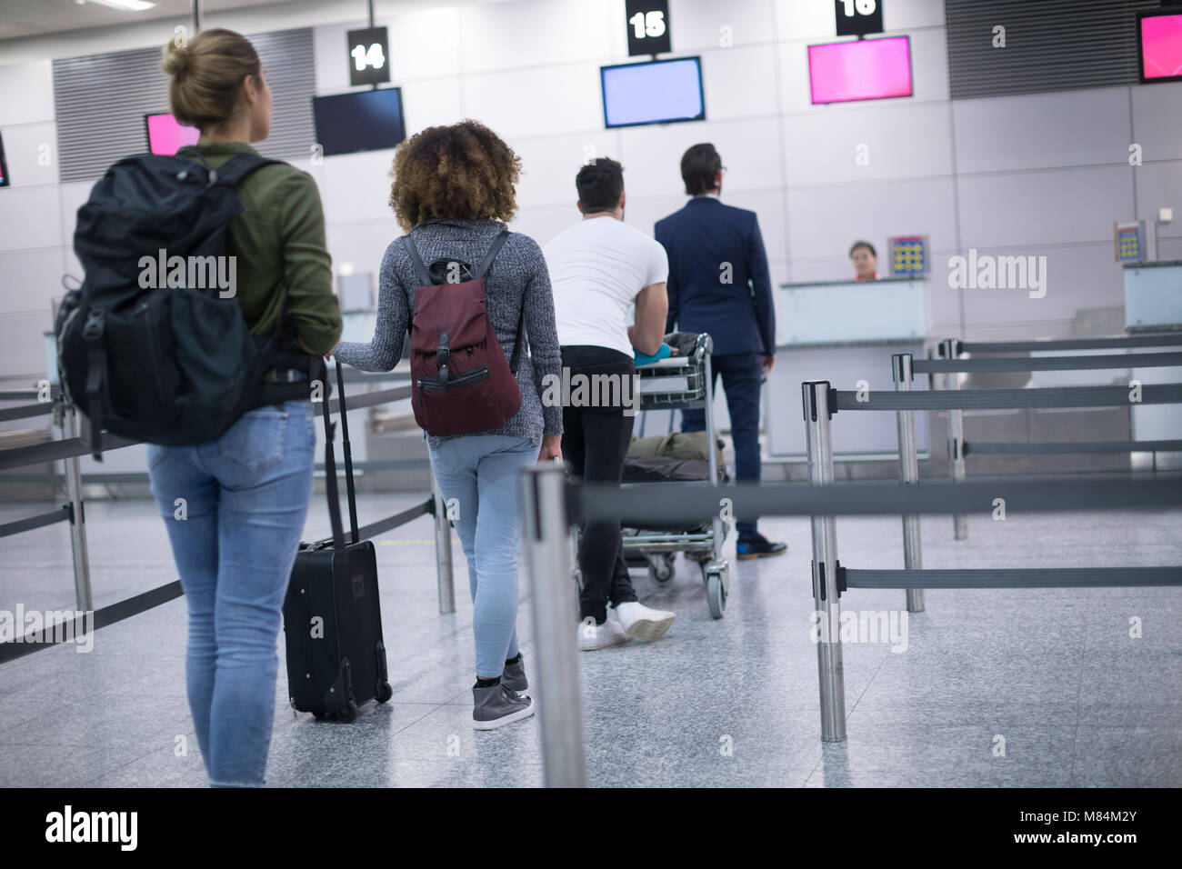 Commuters standing in queue for check-in Stock Photo - Alamy