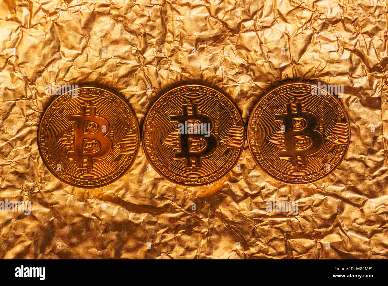 Bitcoin, blockchain cryptocurrency golden coin on gold metal background ...