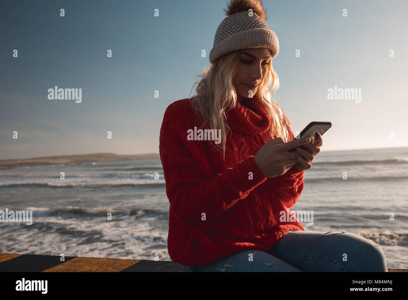 Woman using mobile phone at beach Stock Photo - Alamy