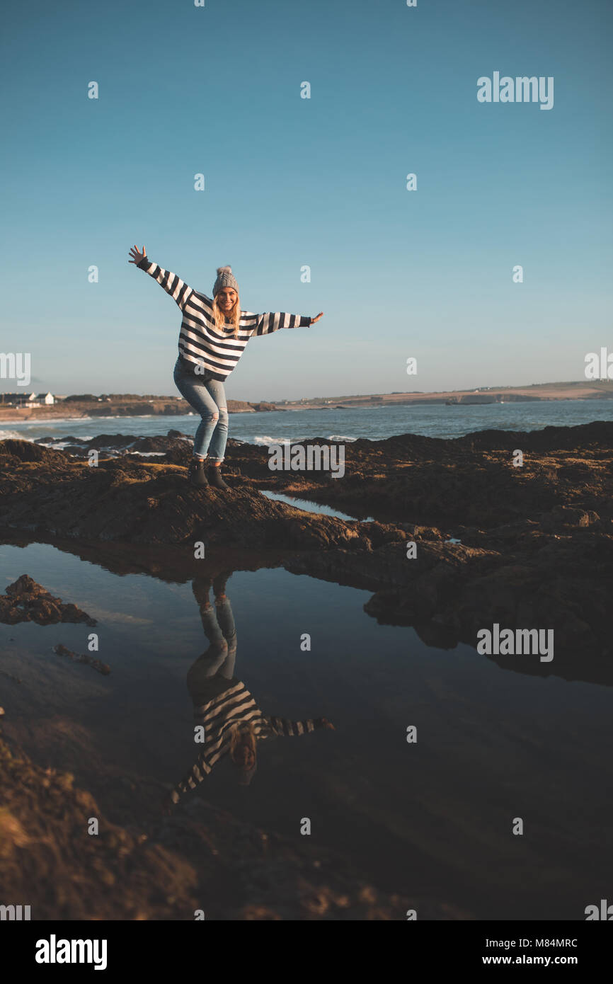 Woman standing with arms outstretched at beach Stock Photo - Alamy