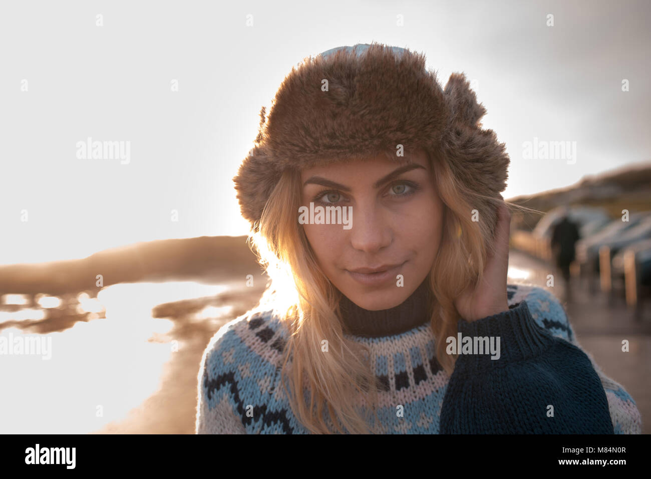 Woman standing on a beach at dusk Stock Photo - Alamy