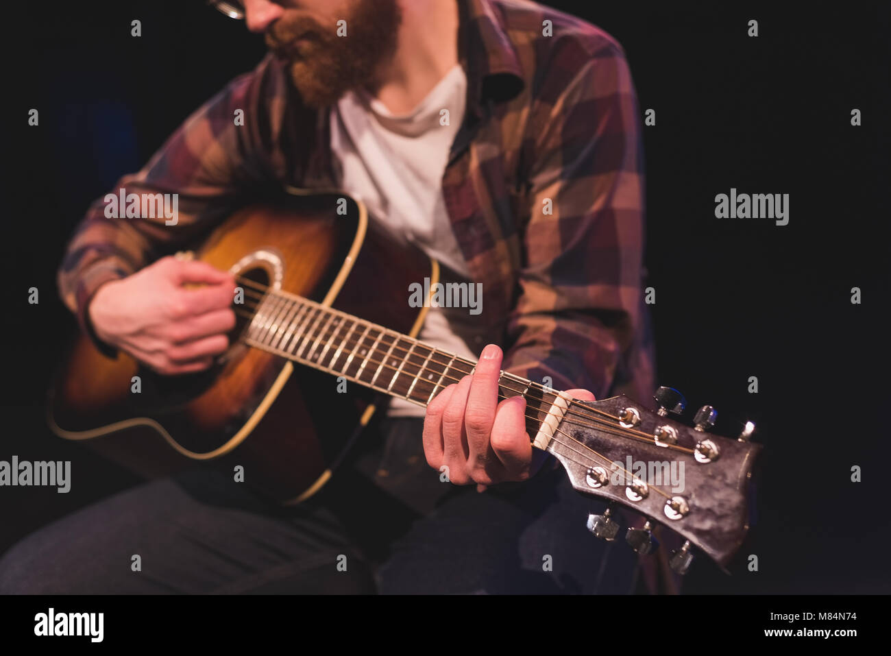 Man playing guitar on stage Stock Photo - Alamy