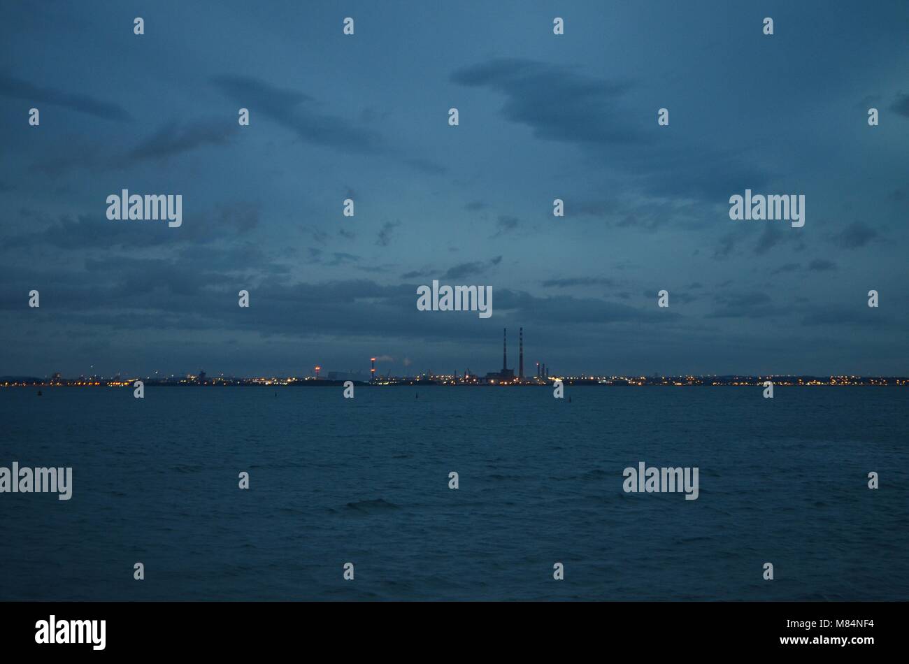 The Poolbeg Chimneys visible on the Dublin Skyline at Dusk Stock Photo ...