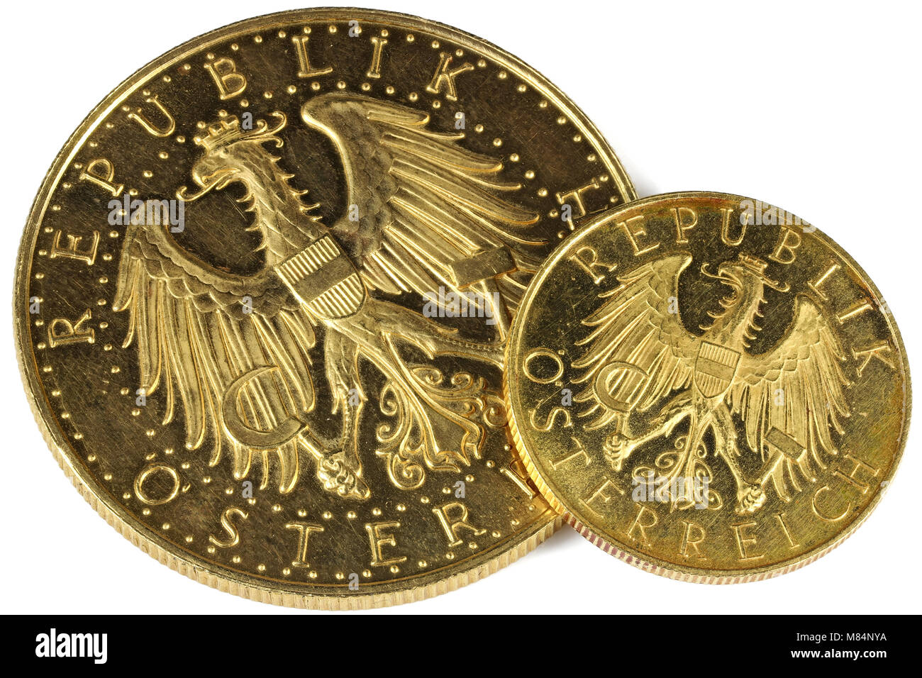 Austrian 25 and 100 Schilling gold coins isolated on white background ...