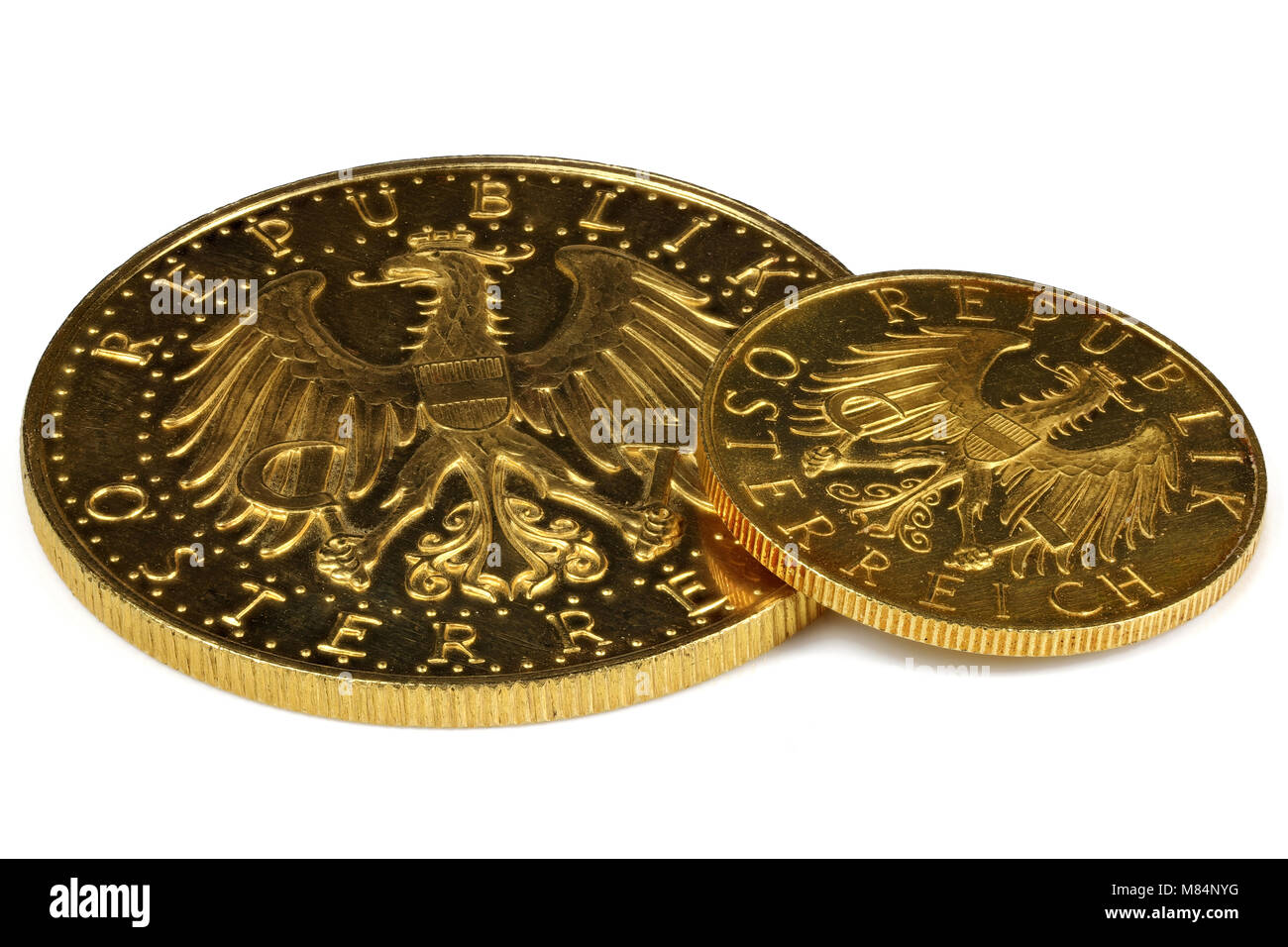 Austrian 25 and 100 Schilling gold coins isolated on white background ...