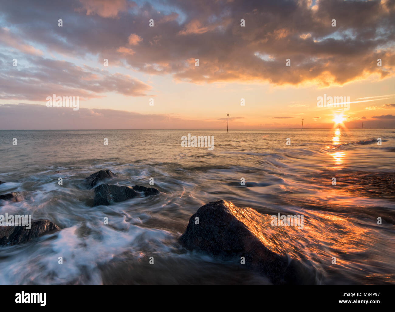 Sunset on a pebble beach with views towards Bognor Regis pier, Selsey ...