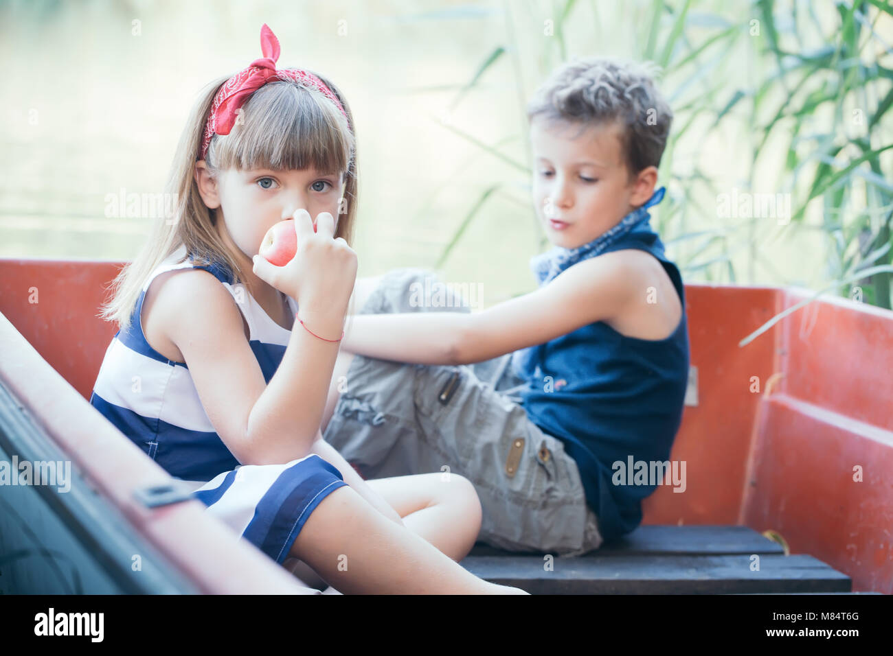 Family and friends summer vacation. Children ride on a boat outdoors ...
