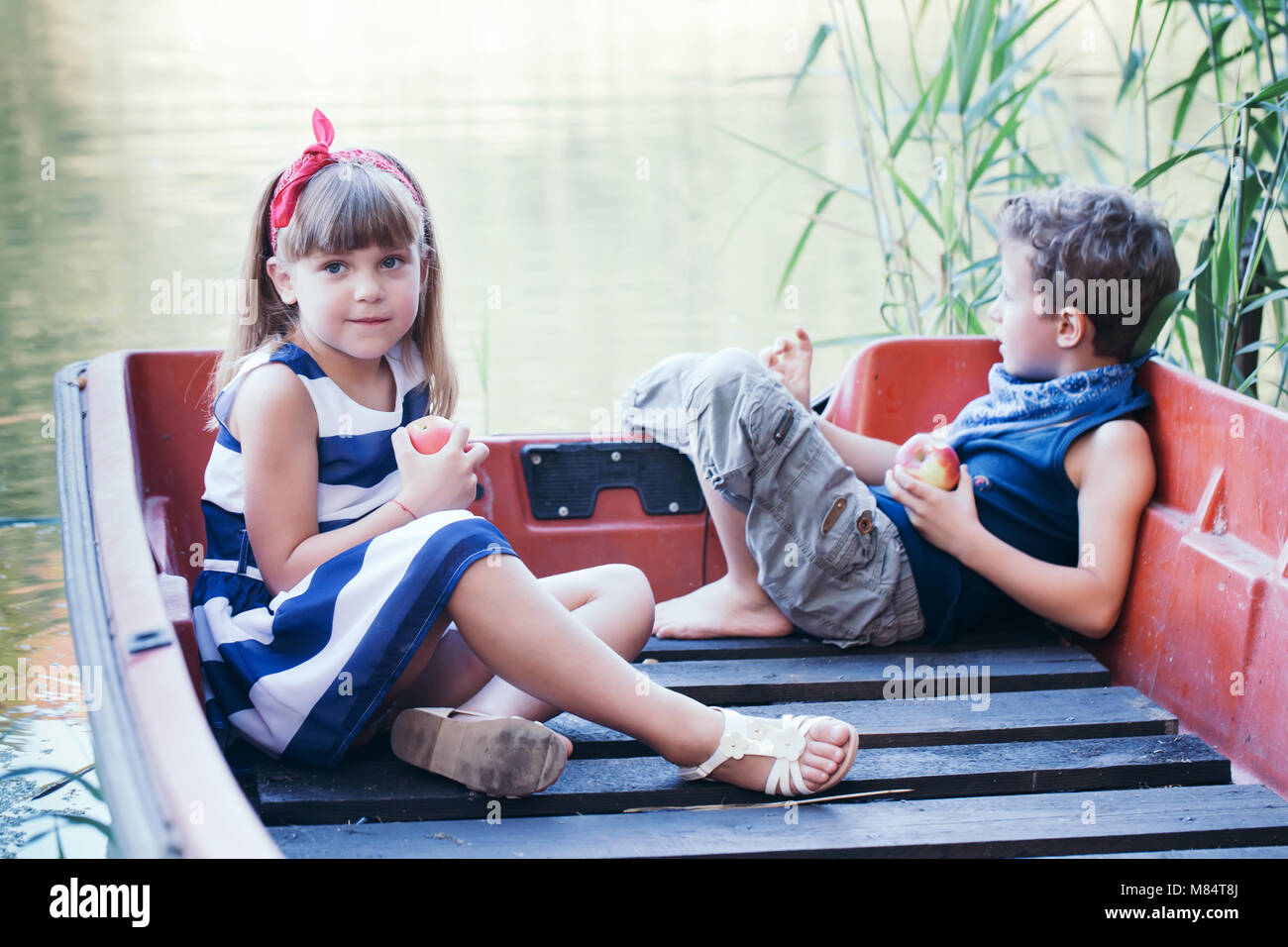 Family and friends summer vacation. Children ride on a boat outdoors ...