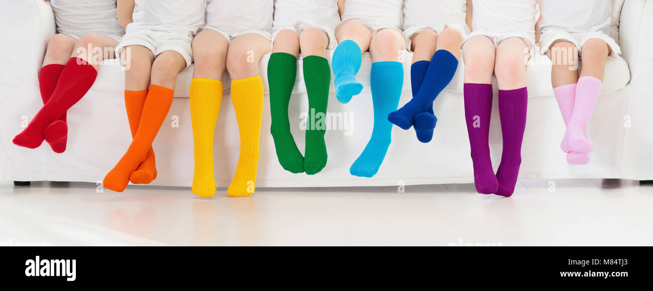 Kids wearing colorful rainbow socks. Children footwear collection ...
