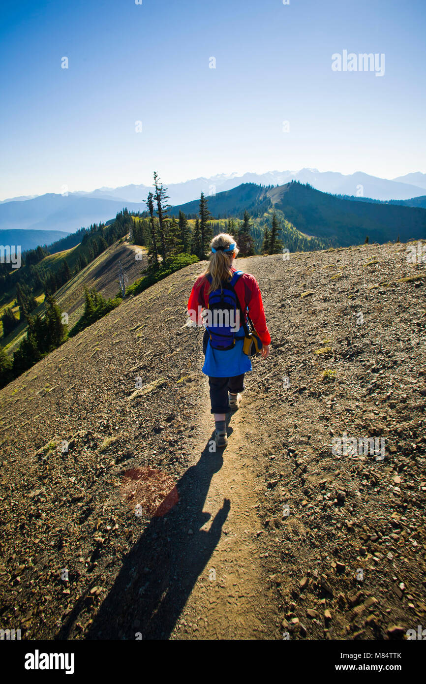 A woman hiking the High Ridge Nature Trail near Hurricane Ridge in ...