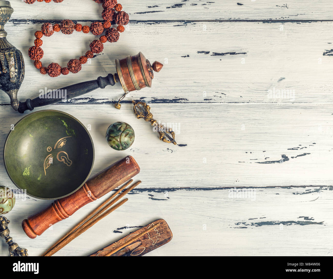 Copper singing bowl, prayer beads, prayer drum, stone balls and other ...