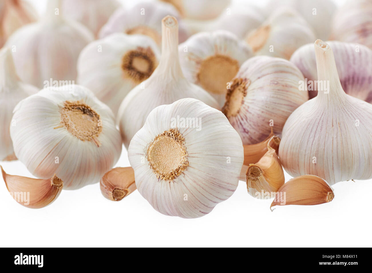 background of garlic a lot of garlic on a white background Stock Photo ...