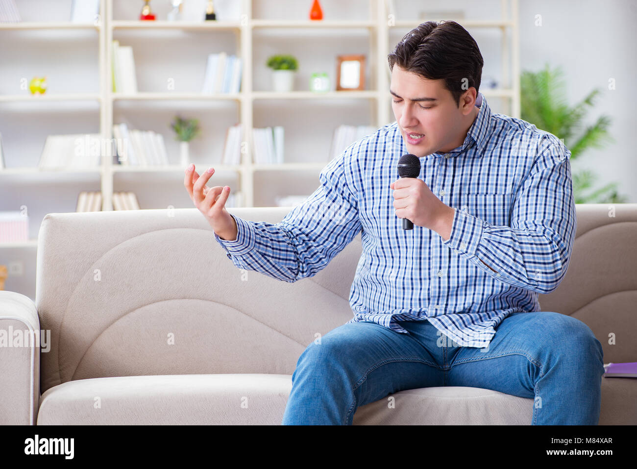 Funny man singing songs in karaoke at home Stock Photo - Alamy