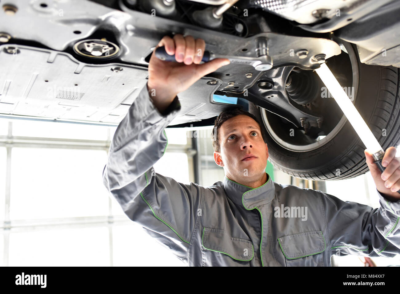 car mechanic in a workshop - engine repair and diagnosis on a vehicle ...