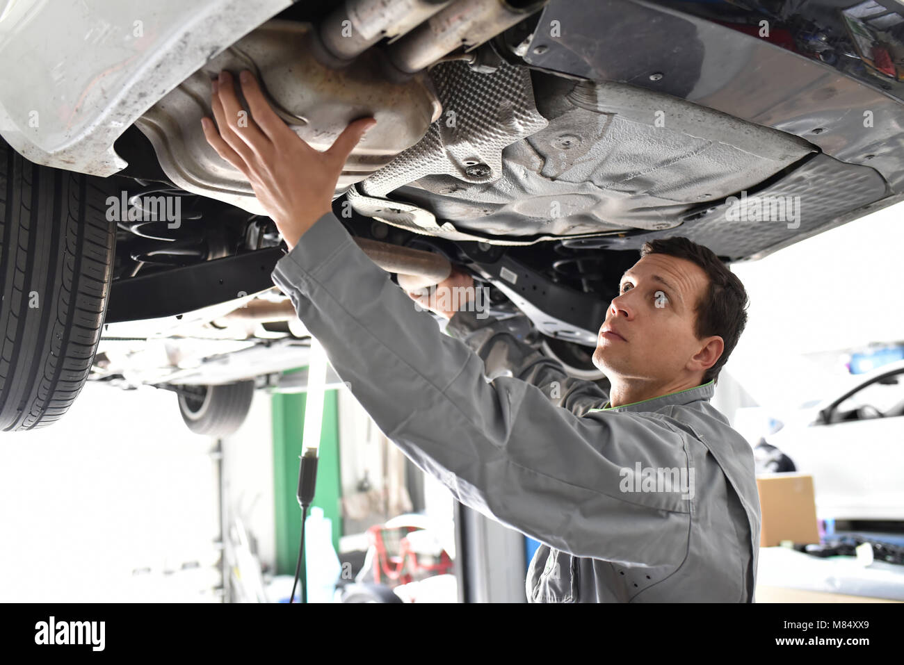 car mechanic works in a workshop, repair of cars Stock Photo - Alamy