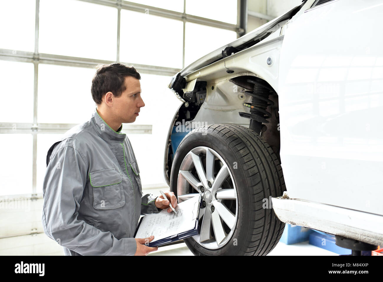 service and inspection of a car in a workshop - mechanic inspects the ...