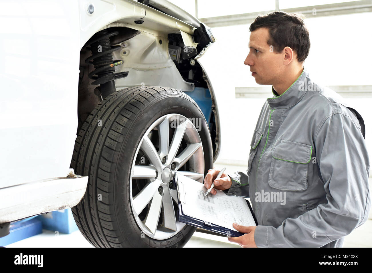 service and inspection of a car in a workshop - mechanic inspects the ...