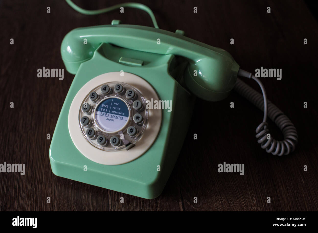 An old fashioned, vintage telephone with rotary or circular dial in a ...