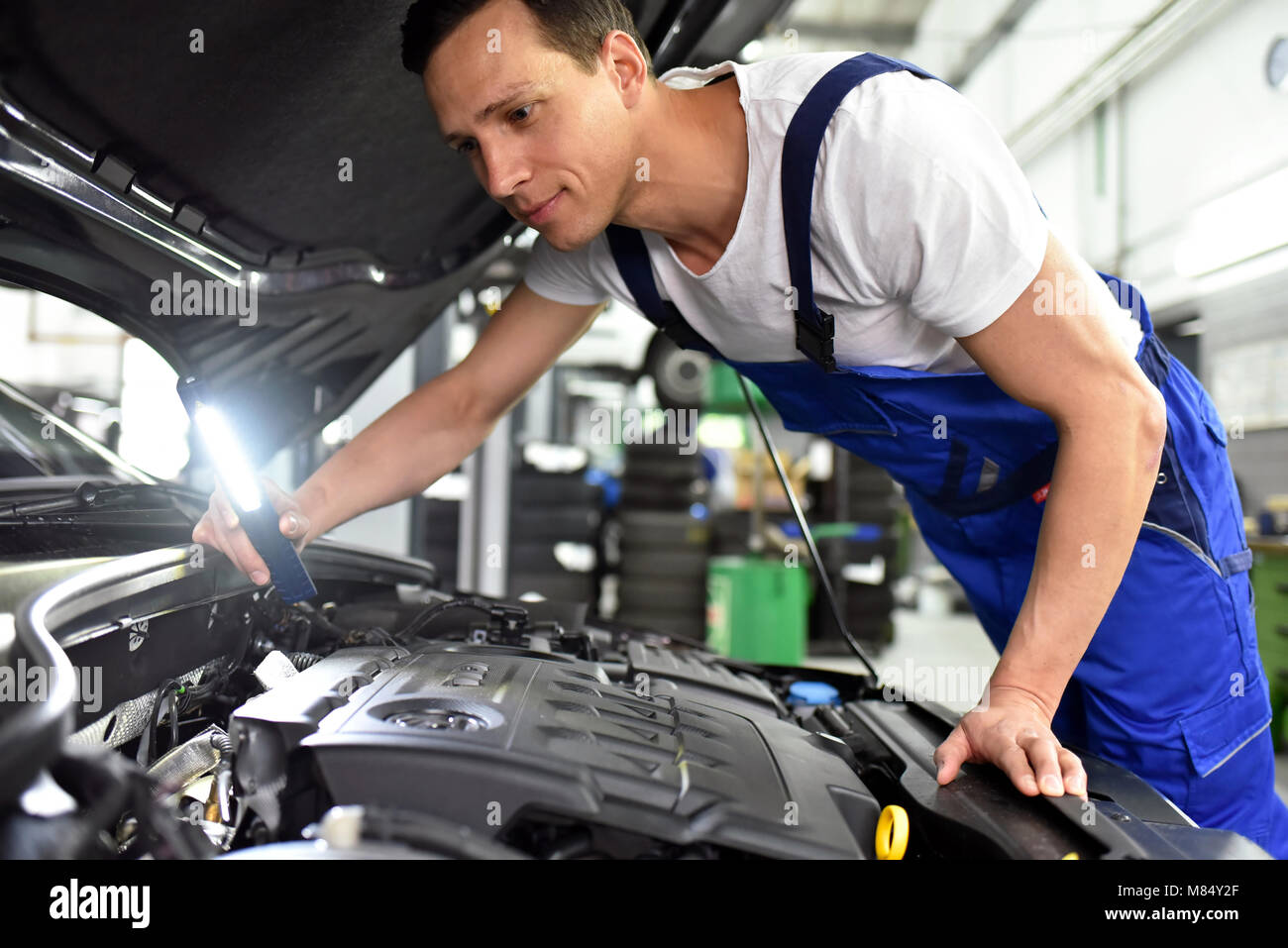 car mechanic in a workshop - engine repair and diagnosis on a vehicle ...