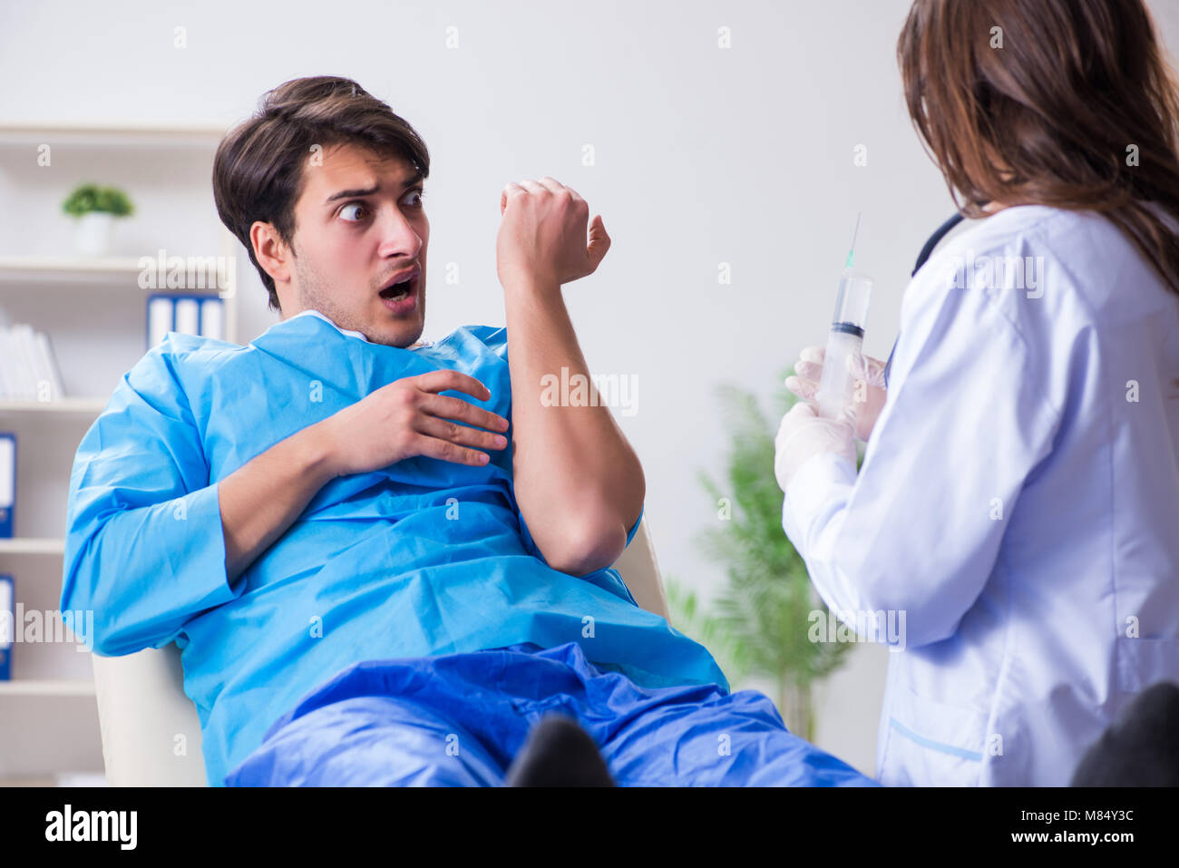 Scared patient man getting ready for flu shot Stock Photo - Alamy