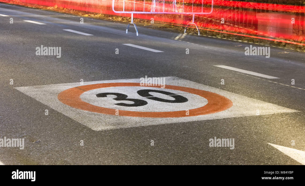 speed limit sign on a tarmac road by night in Italy Stock Photo - Alamy