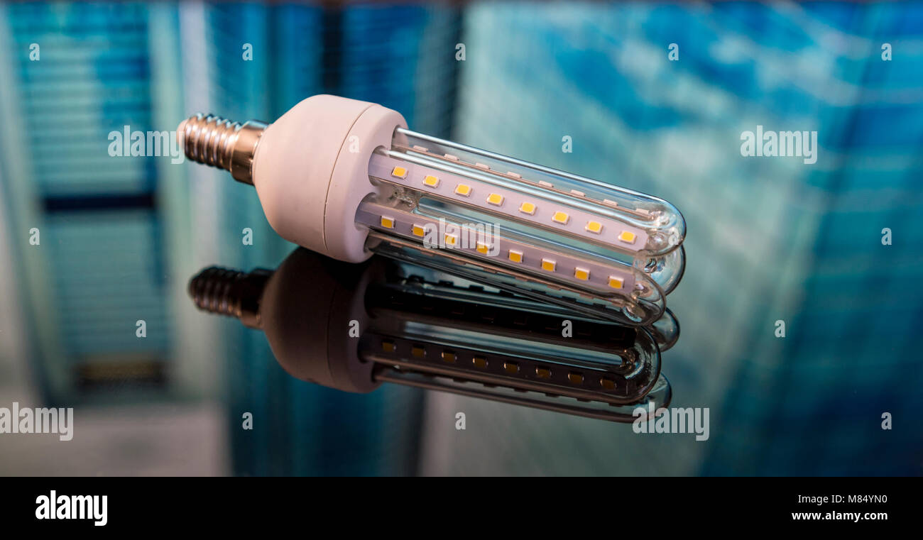 energy saving bulb on black glass. light bulb composed of small LEDs of ...