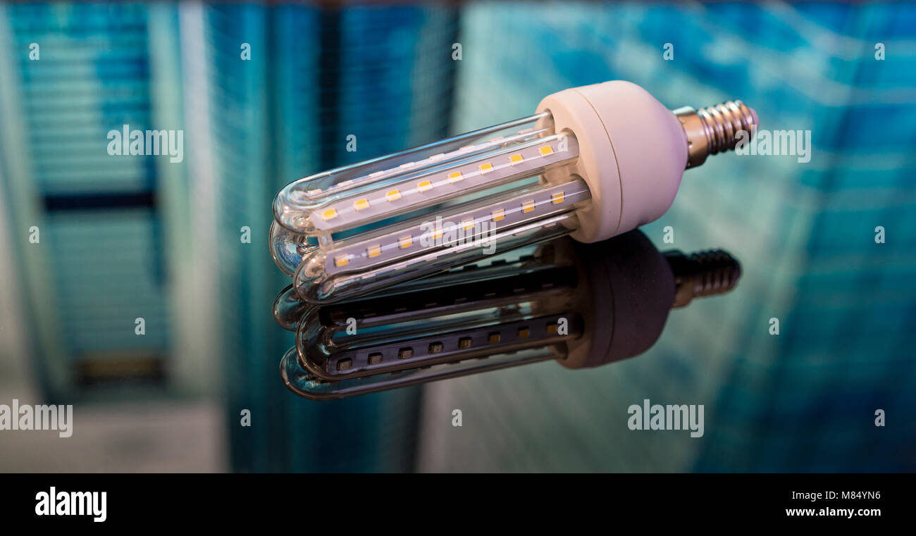 Eco, energy saving bulb on black glass. light bulb composed of small ...