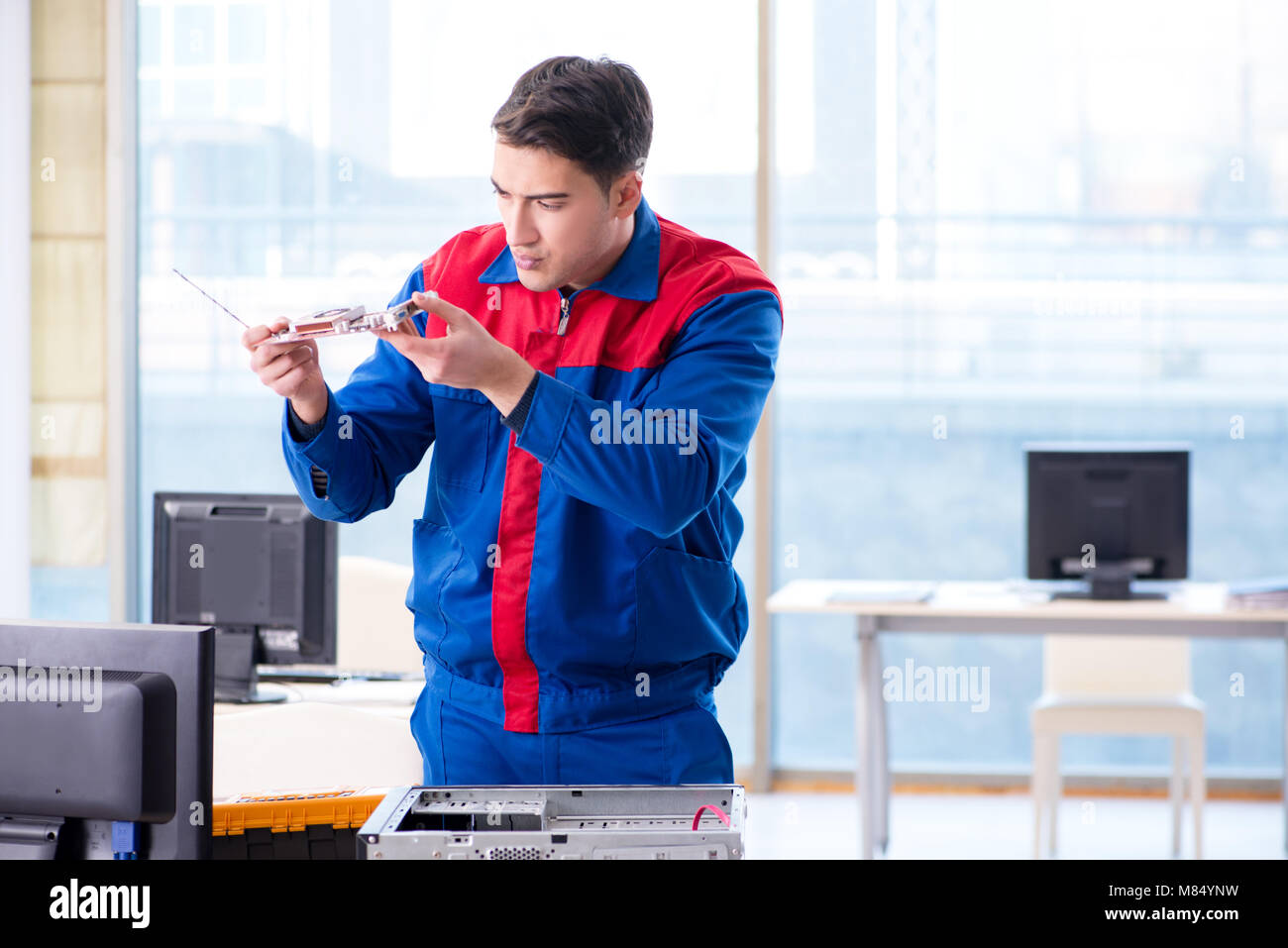 Computer repairman specialist repairing computer desktop Stock Photo ...