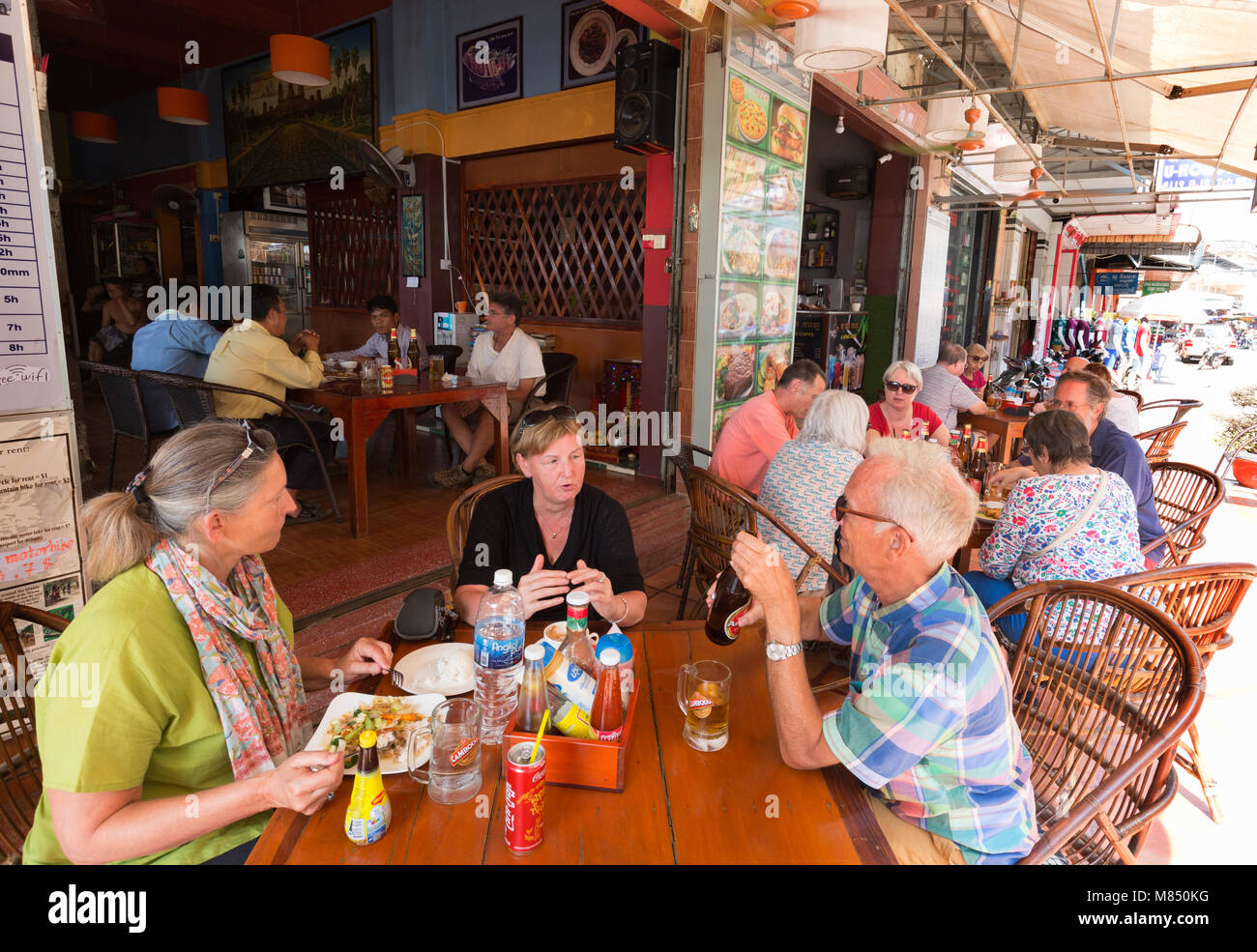 Cambodia cafe - tourists eating and drinking in a cafe, Kampong Cham ...
