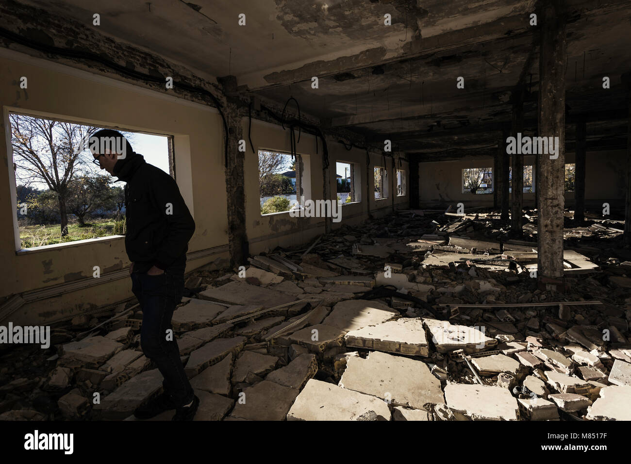 Young boy inside the ruined building Stock Photo - Alamy
