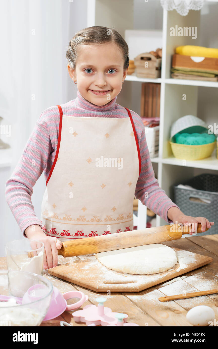Cooking at home, girl in kitchen, making dough, healthy food concept ...