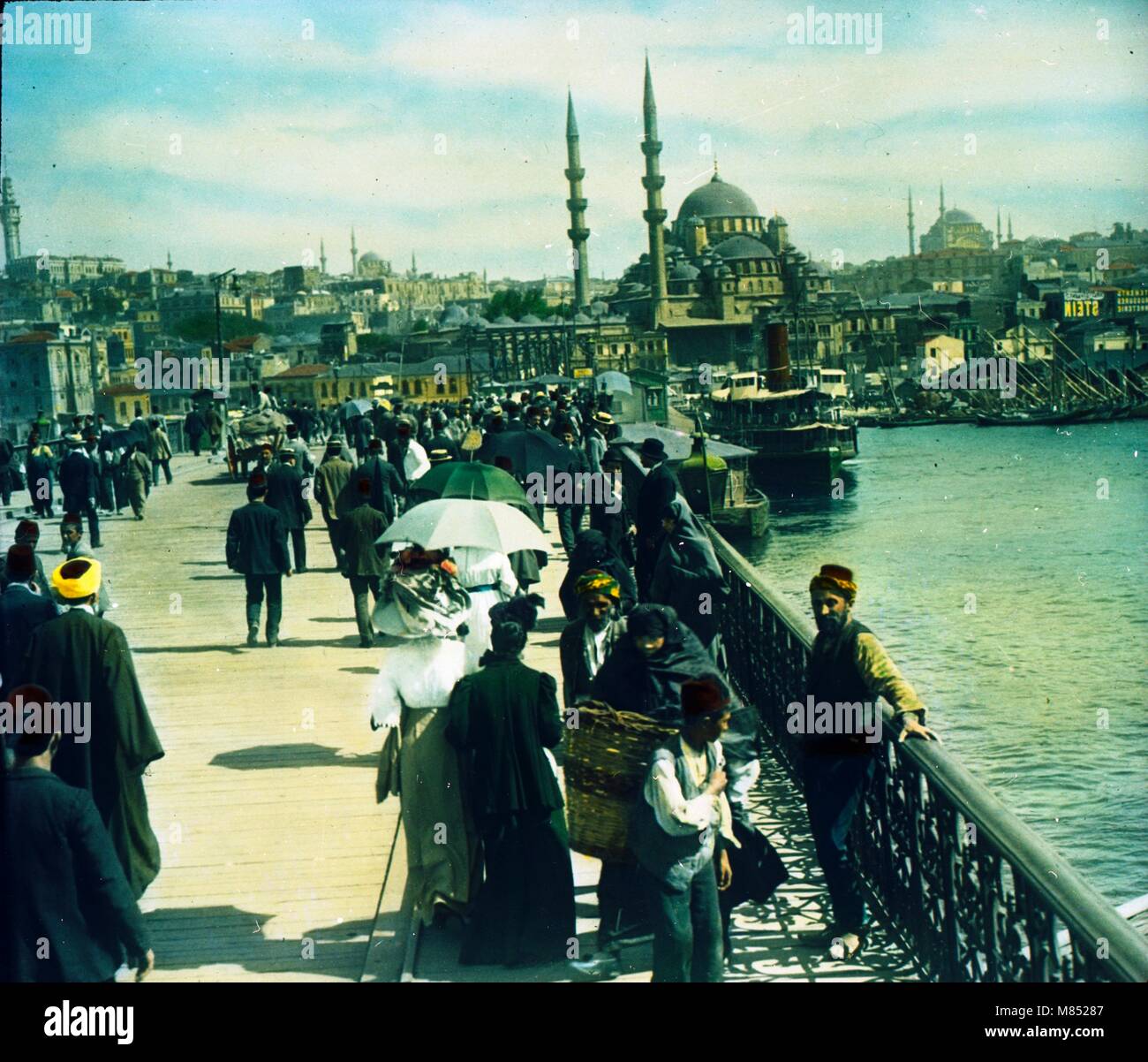 Colorized view of pedestrians walking across the Galata Bridge, with ...
