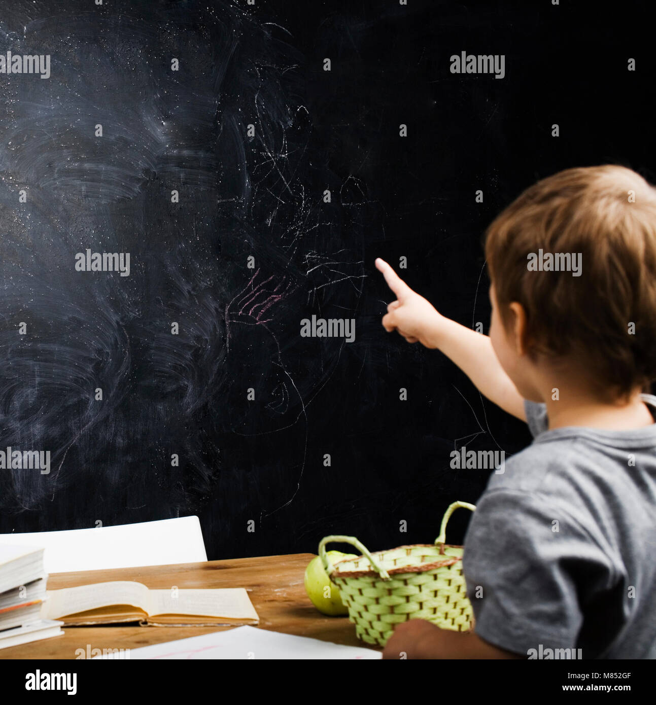 little cute boy in glasses with young real teacher, classroom studying ...