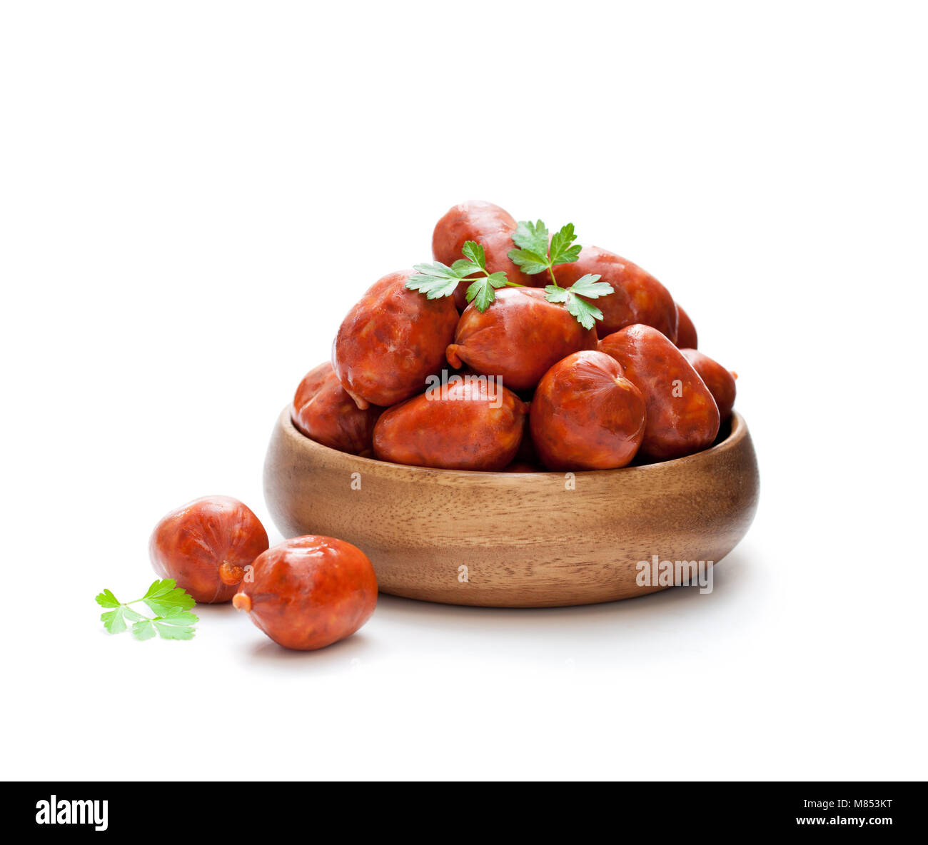 Mini chorizo sausages in wooden bowl isolated on white Stock Photo - Alamy