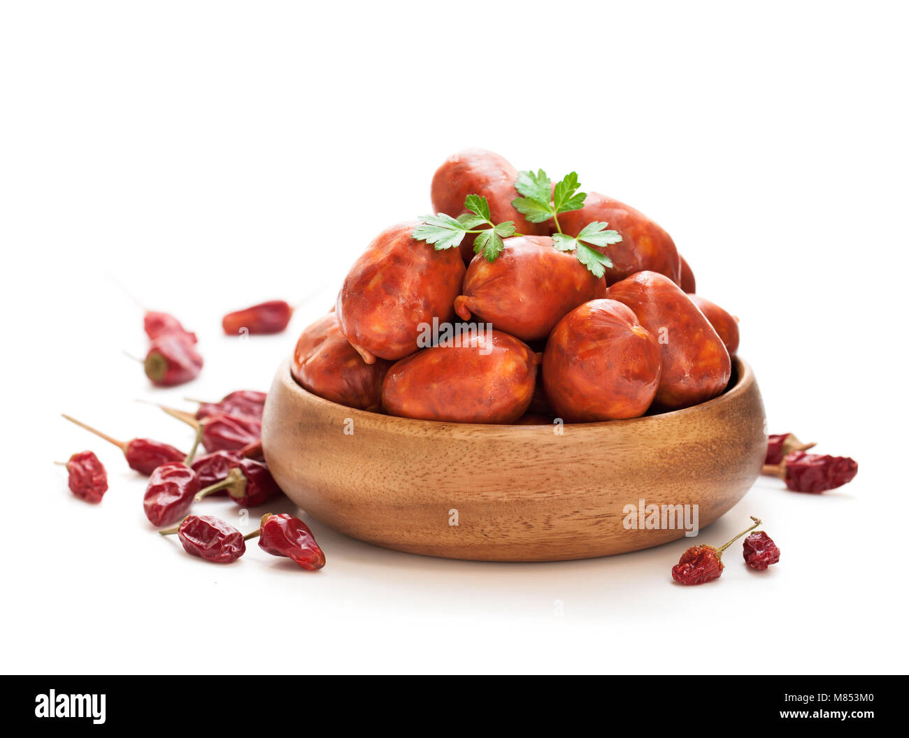 Mini chorizo sausages in wooden bowl isolated on white Stock Photo - Alamy