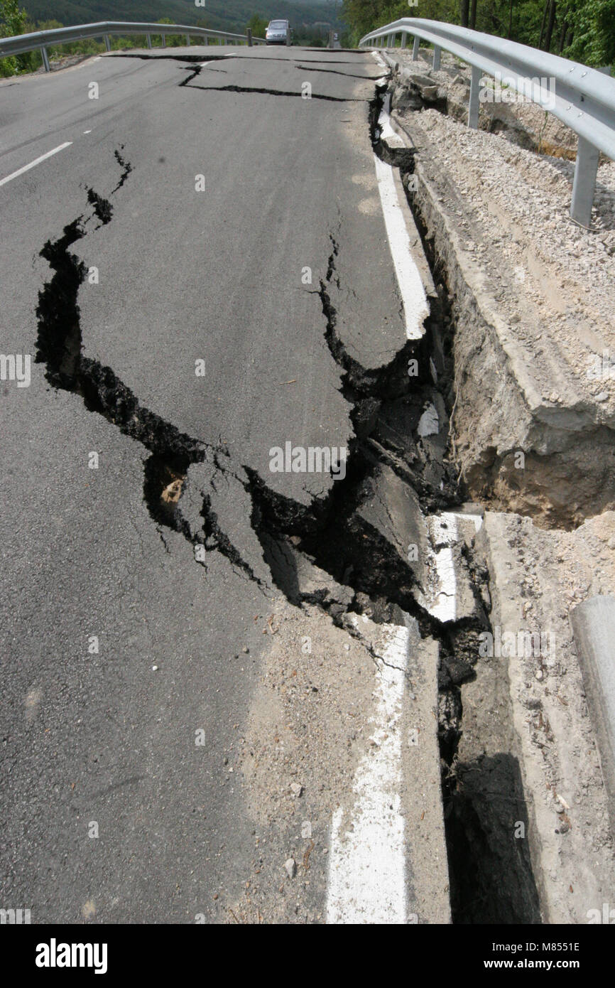Road collapses with huge cracks. International road collapsed down ...