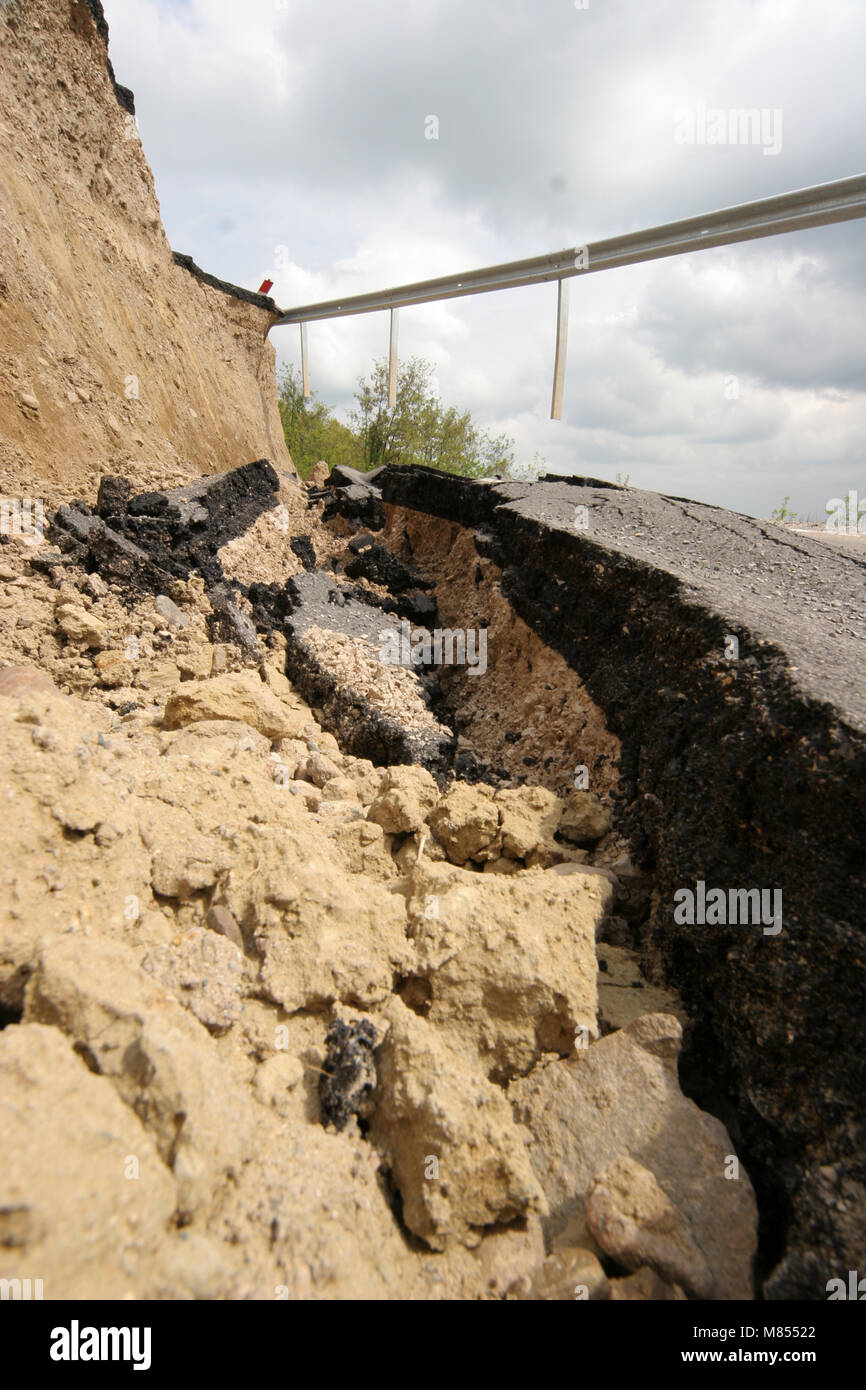 Road collapses with huge cracks. International road collapsed down ...