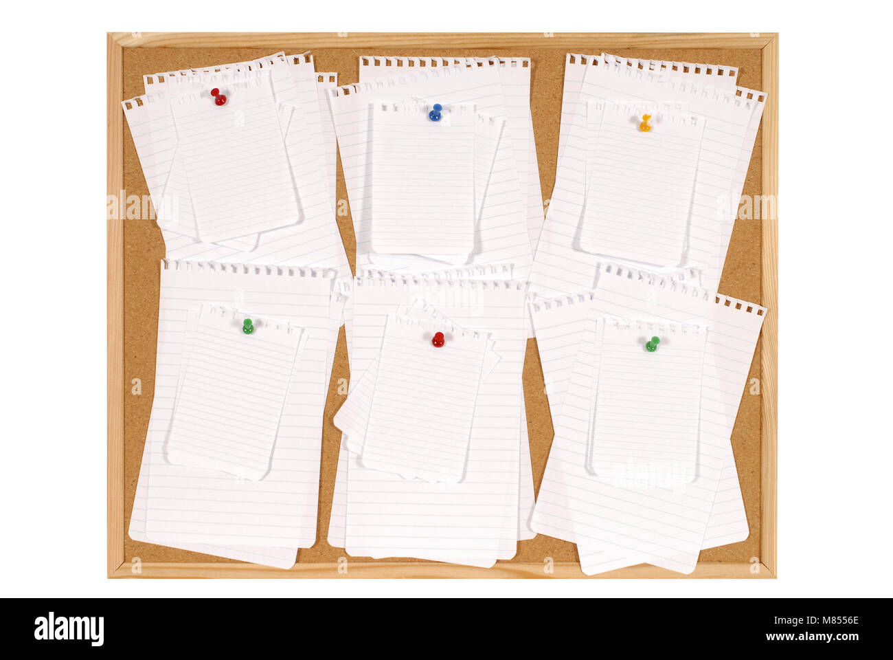 Cork notice or bulletin board with lots of blank sheets of untidy torn ...