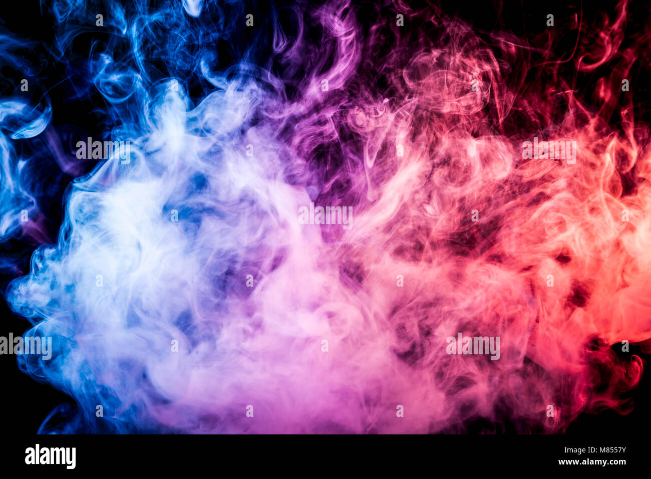 Thick colorful smoke of red and blue on a black isolated background ...
