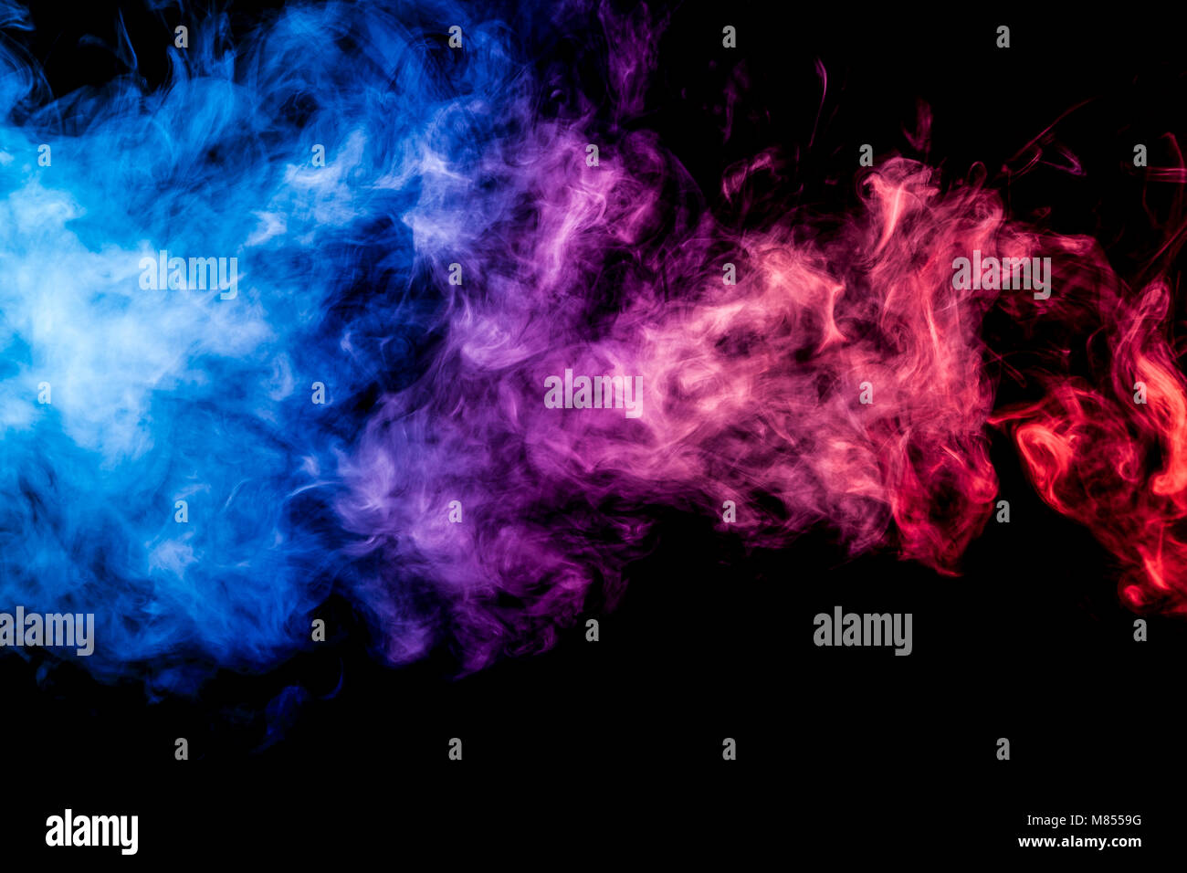 Thick colorful smoke of red and blue on a black isolated background ...