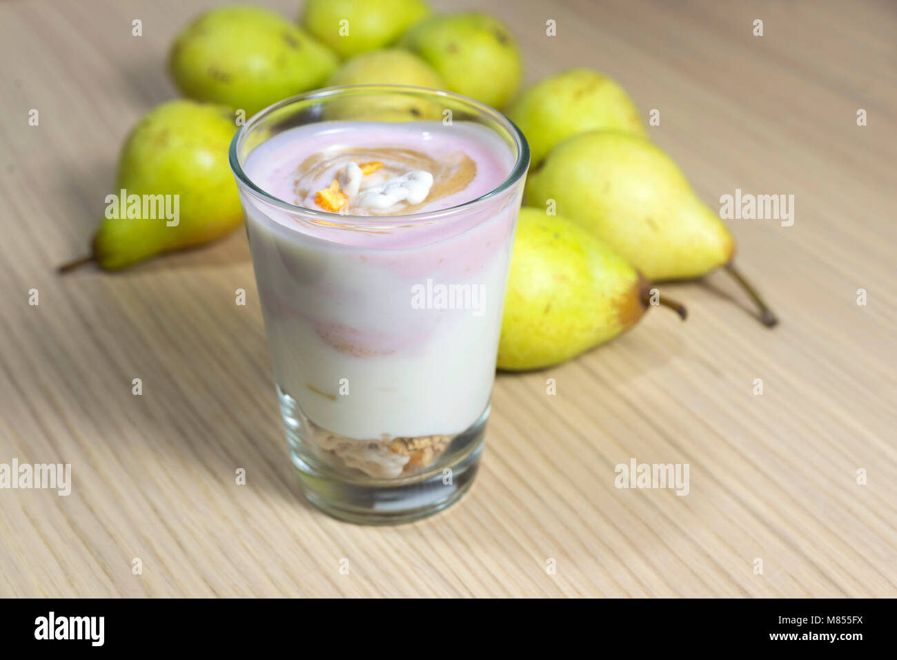 Pear yoghurt in a glass and raw fruits Stock Photo - Alamy
