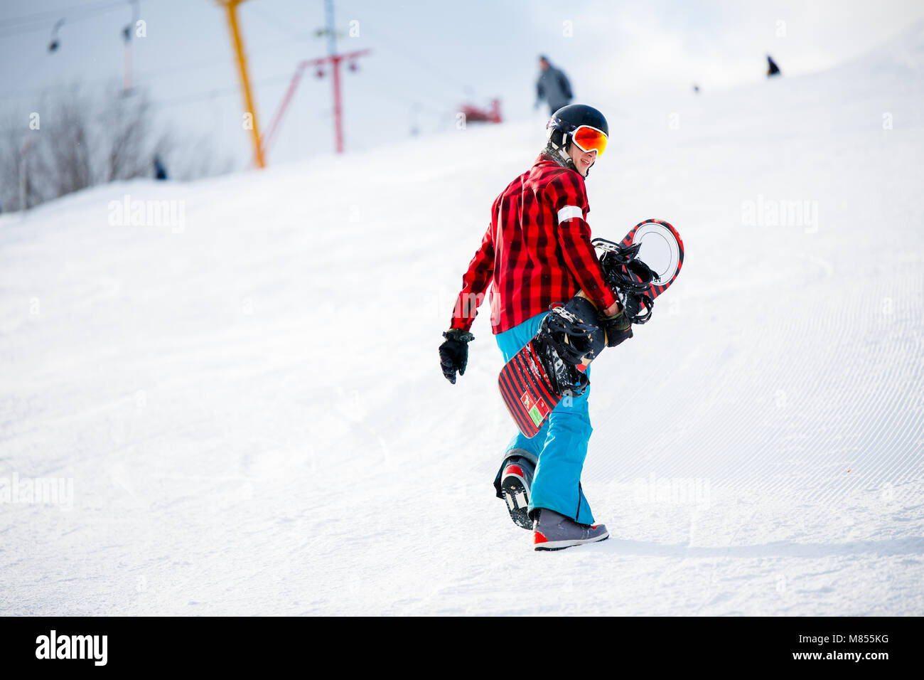 Photo from back of athlete walking with snowboard Stock Photo - Alamy