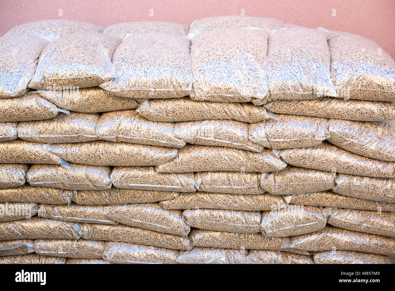 Pile of sacks in a row ful with wooden pellets Stock Photo - Alamy