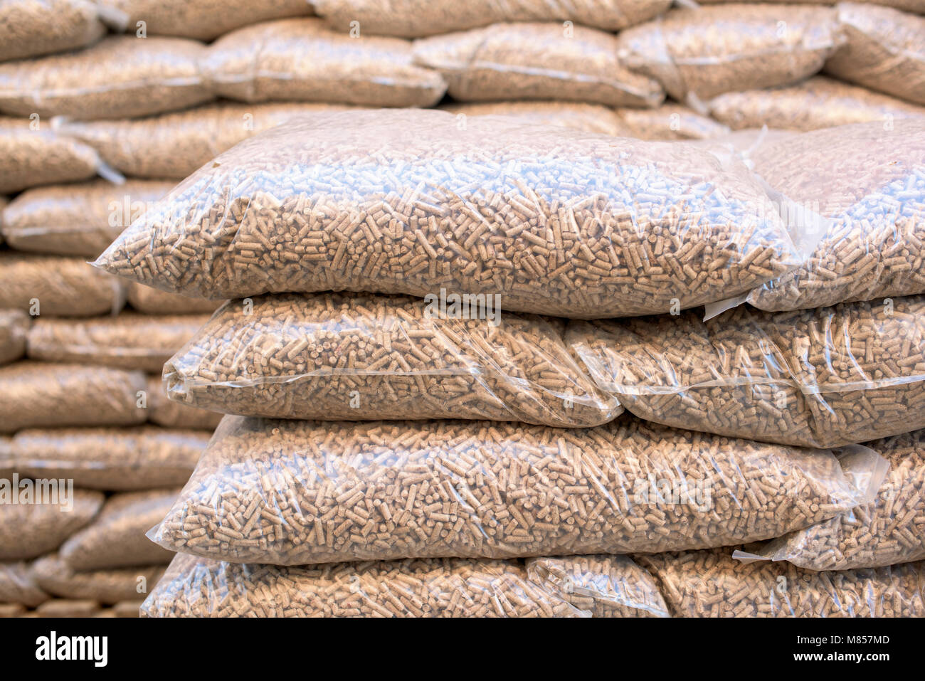 Pile of sacks ful with wooden pellets Stock Photo - Alamy