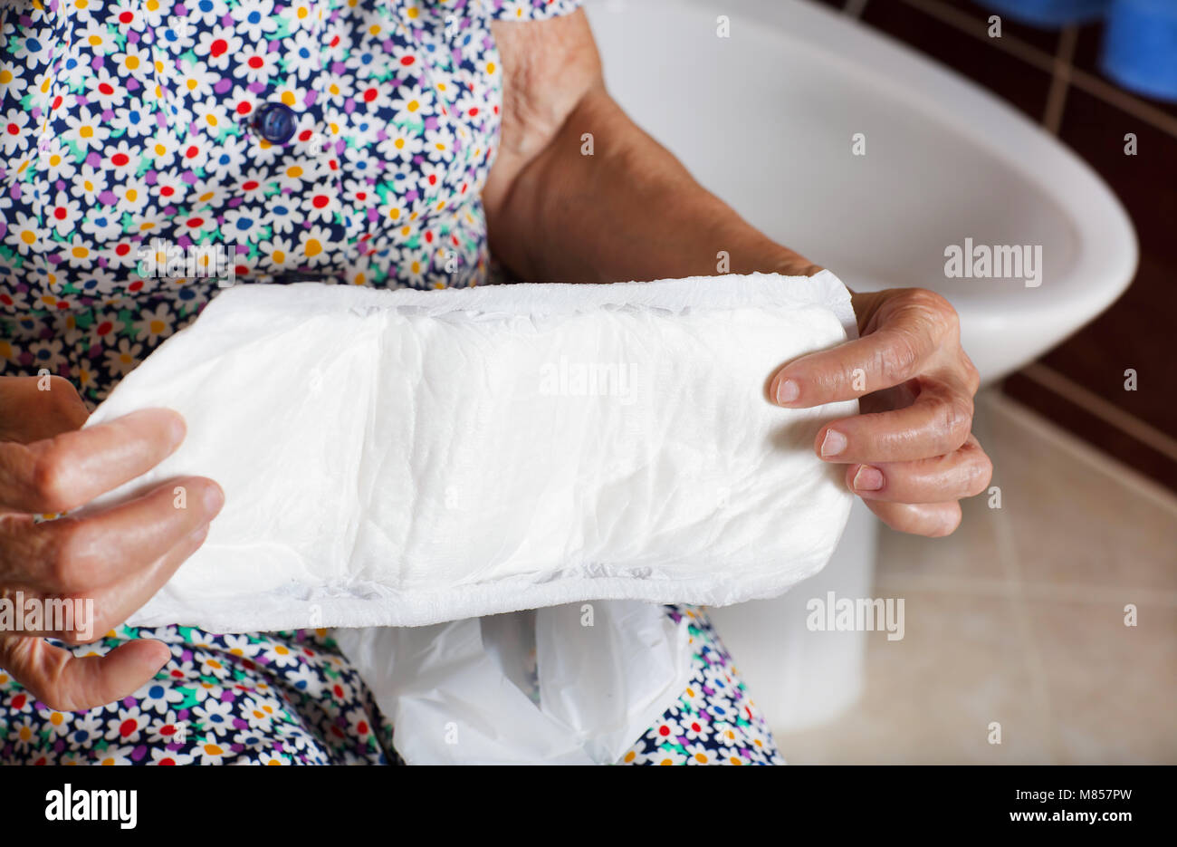 Senior woman between 70 and 80 years old keeps incontinence liners in ...