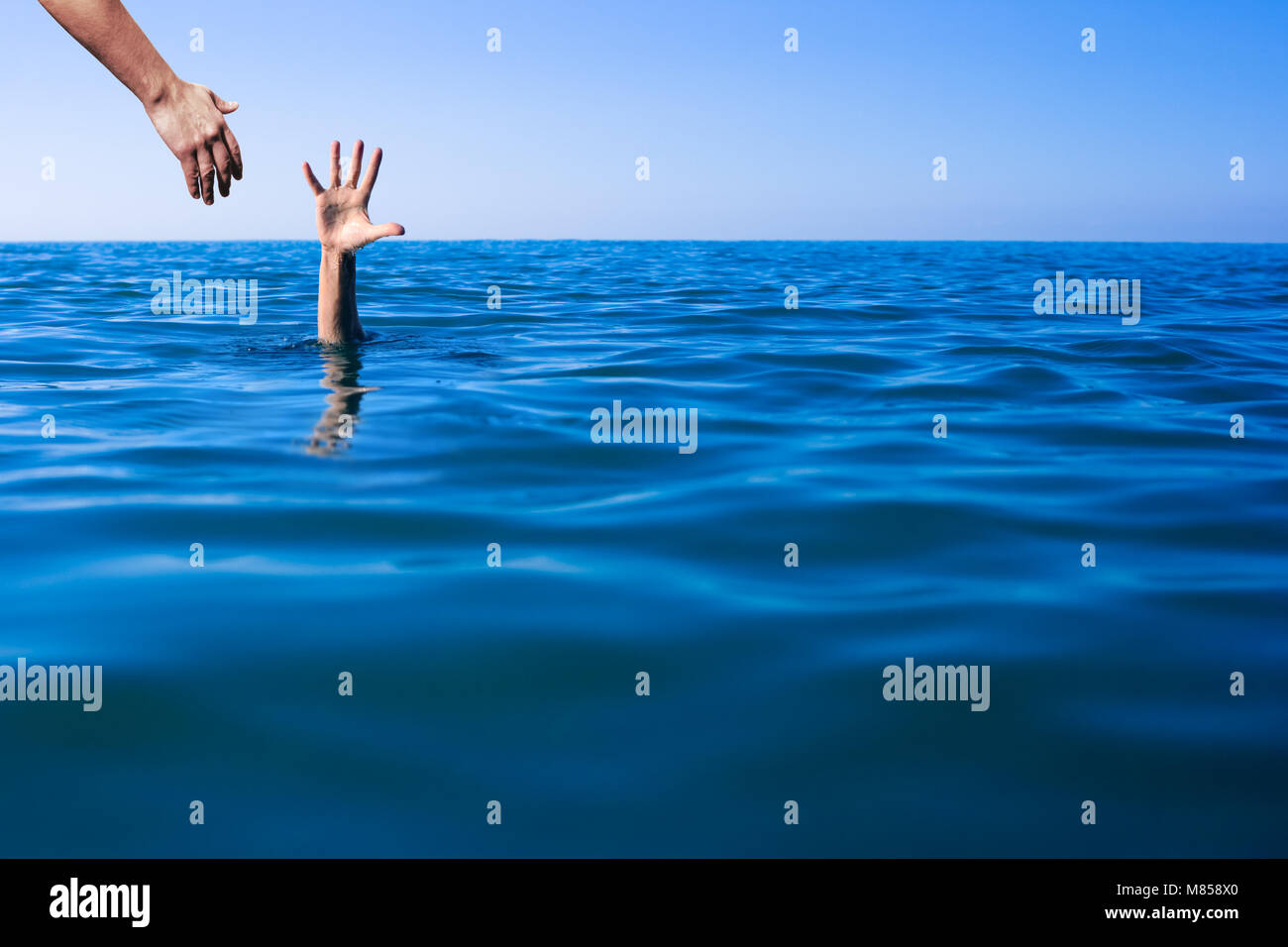 Help hand for drowning man life saving in sea or ocean Stock Photo - Alamy