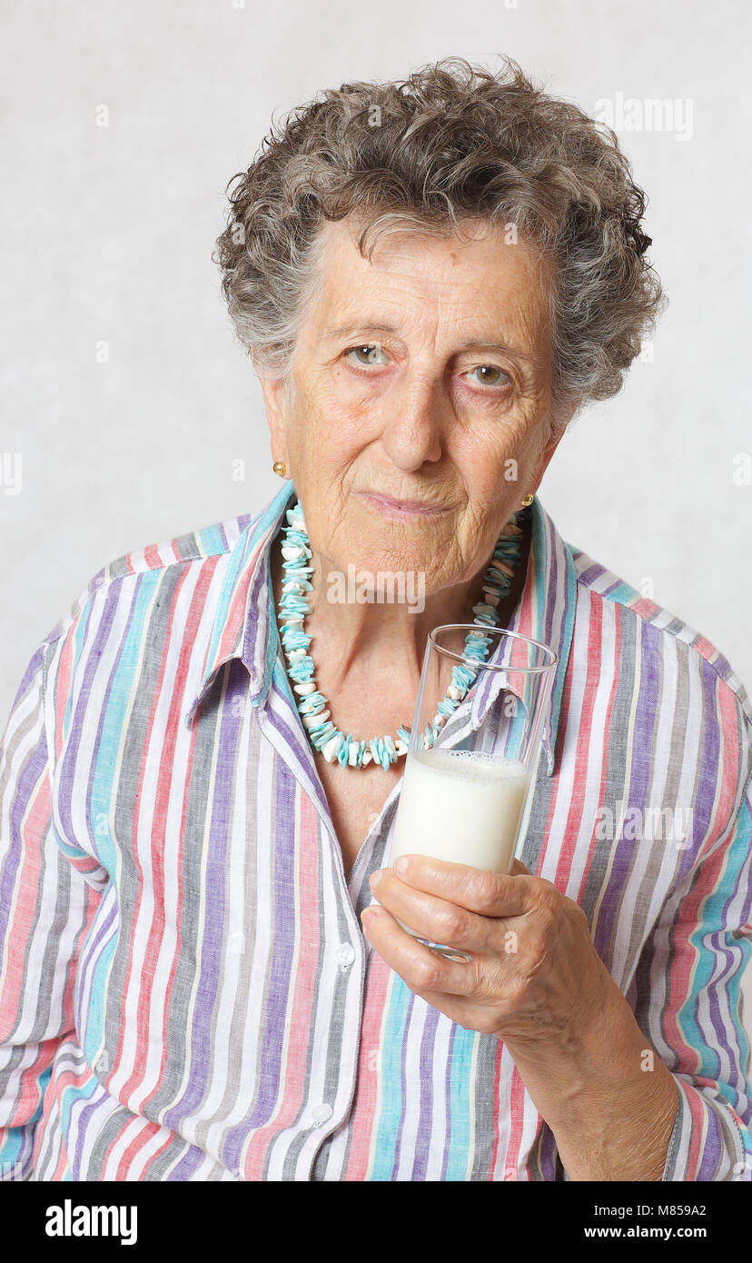 Senior Woman Between 70 And 80 Years Old And A Glass Of Milk Stock