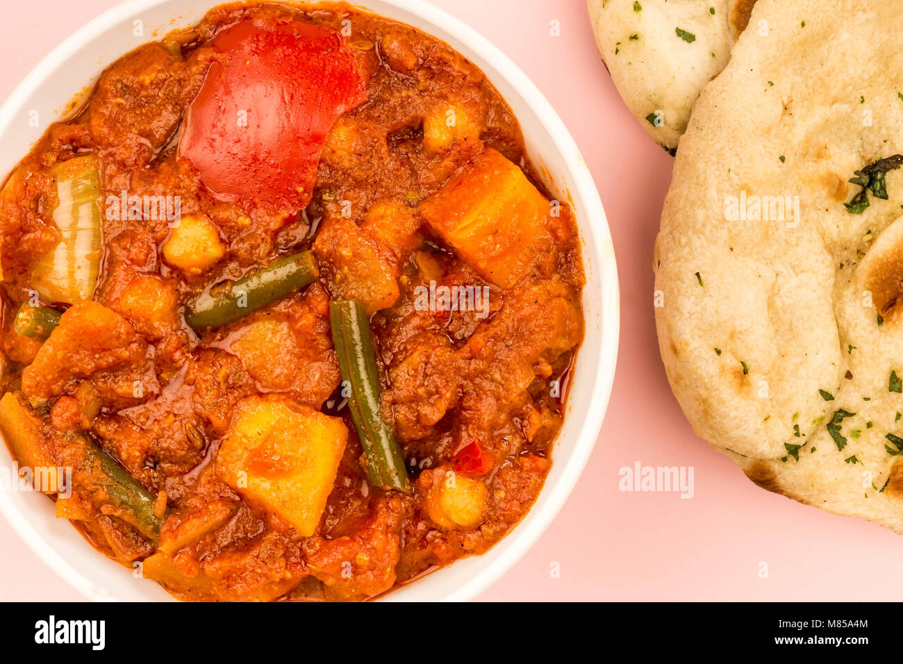 Indian Style Vegetarian Masala Curry Against A Pink Background With ...