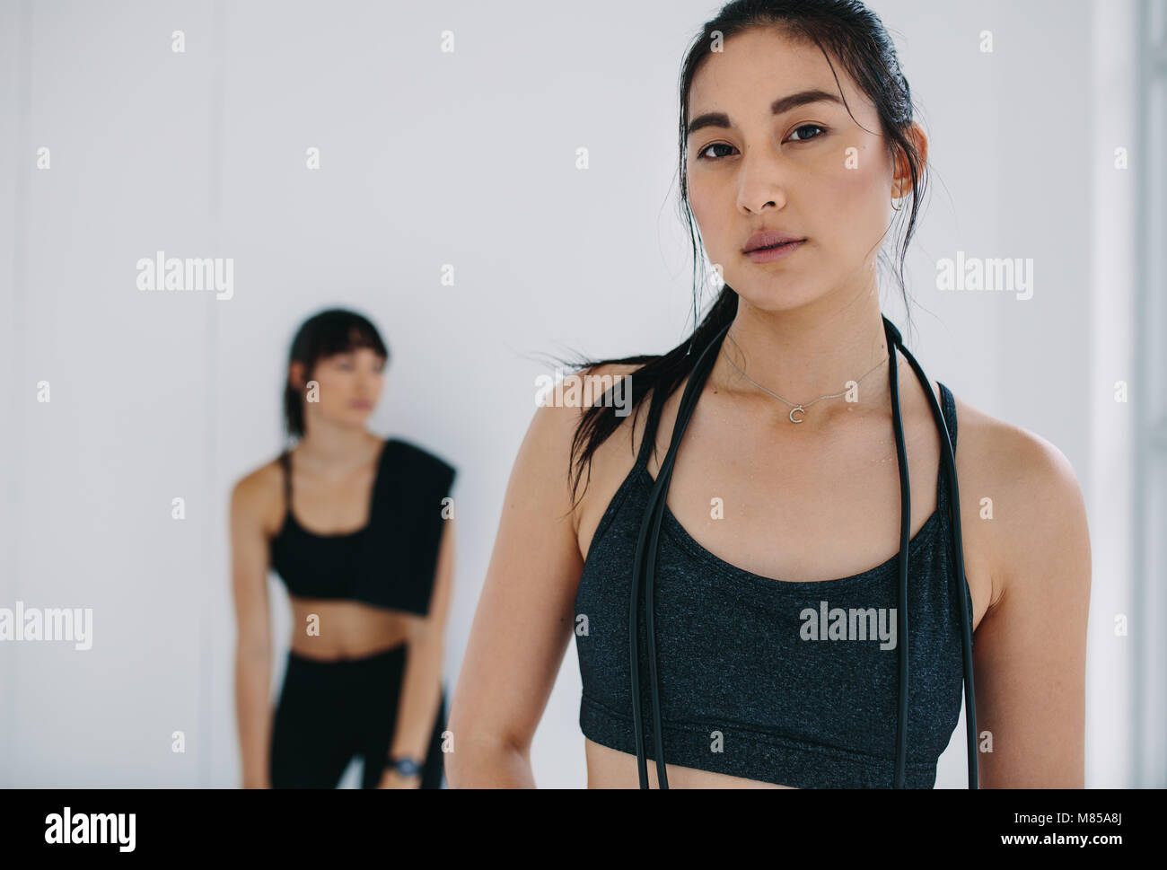 Close up portrait of fitness woman with skipping ropes around her neck ...