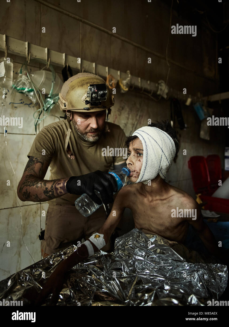 An injured Yazidi boy is treated by volunteer medic Jonathan Rieth at a ...